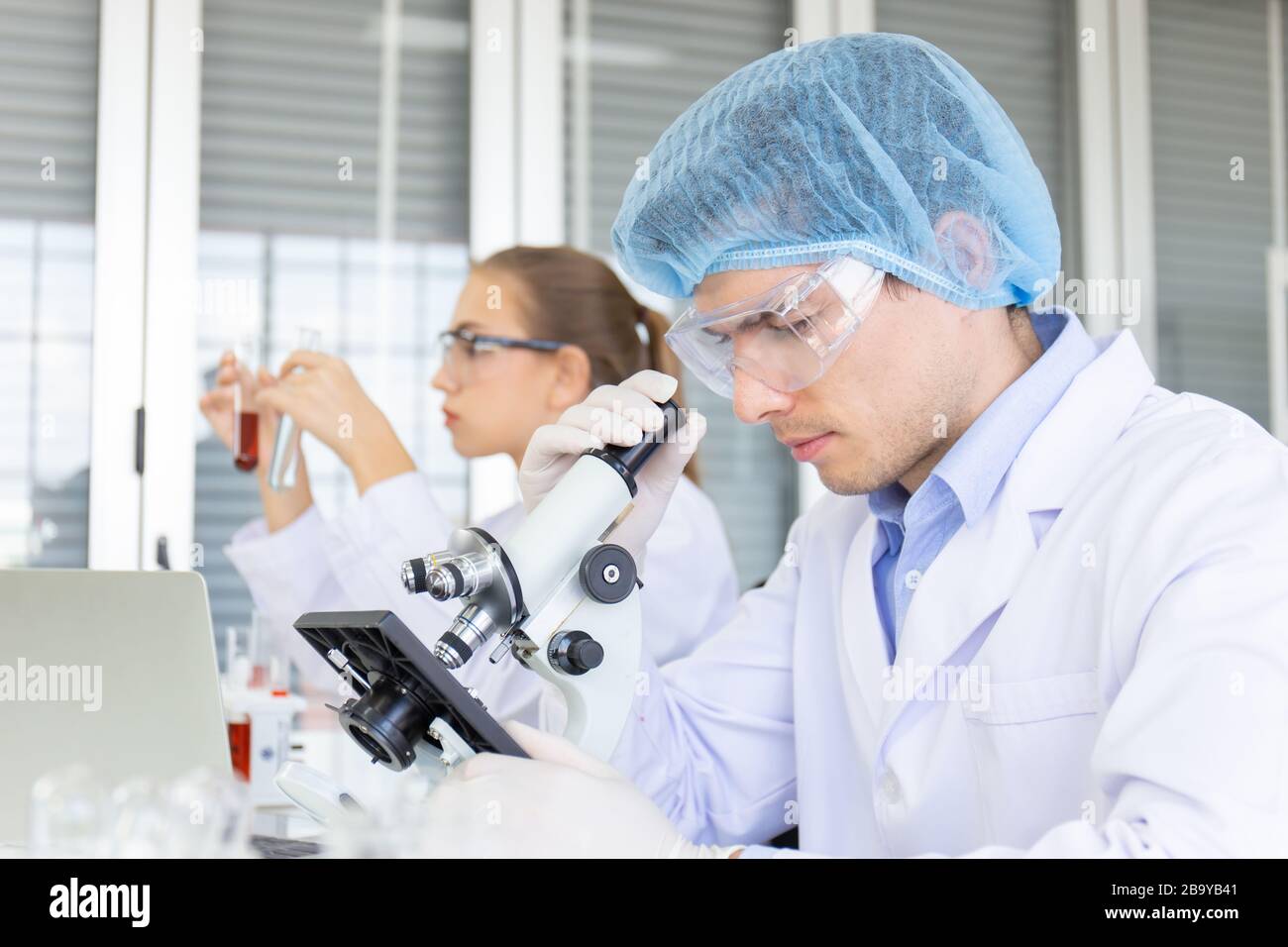 Young scientist shaking test tube hi-res stock photography and images ...