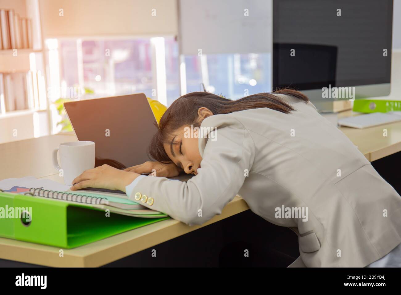 A young Asian professional businesswoman is sleeping on her desk Stock ...