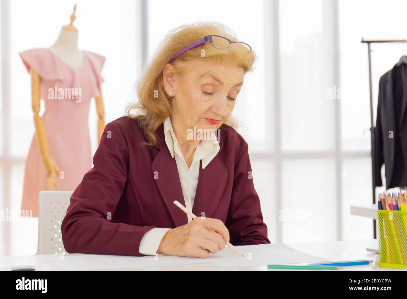 Professional female designers are drawing sketches on paper in the ...