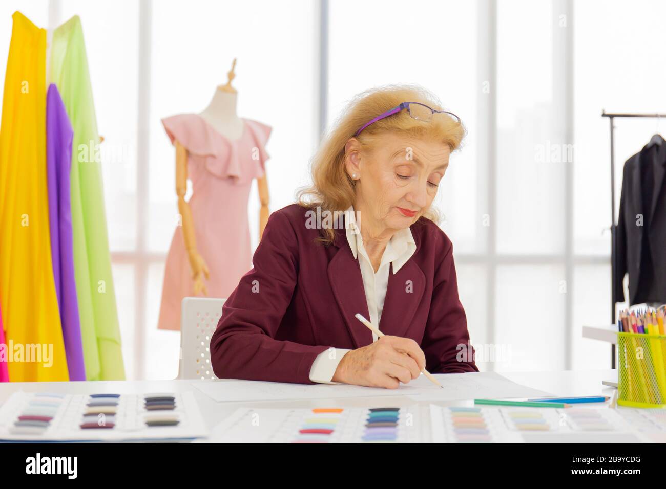 Professional female designers are drawing sketches on paper in the ...