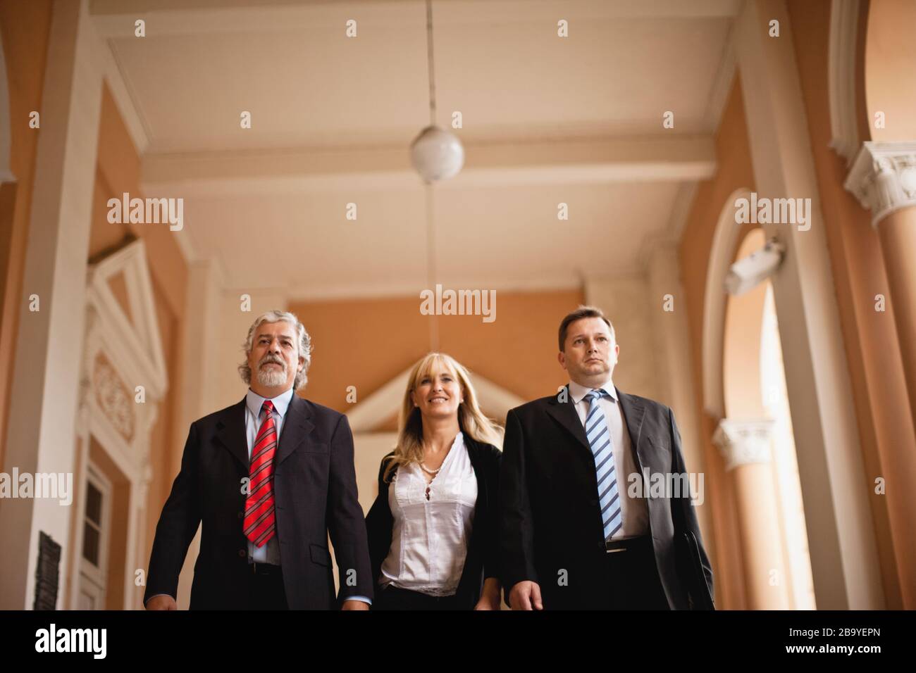 Three colleagues walking together Stock Photo - Alamy