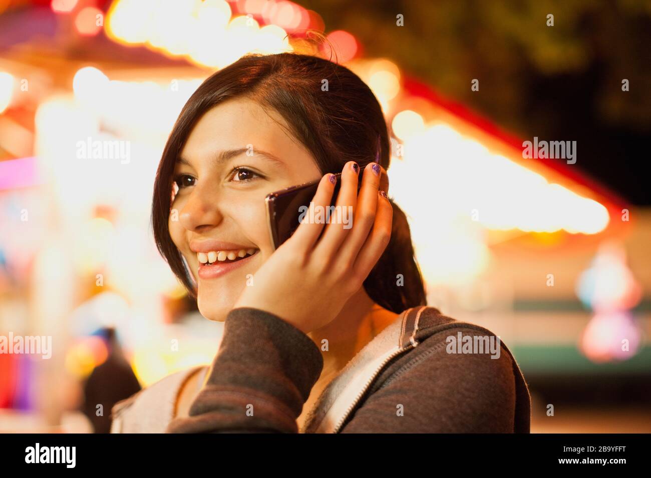 Teenage girl listening on cell phone Stock Photo - Alamy