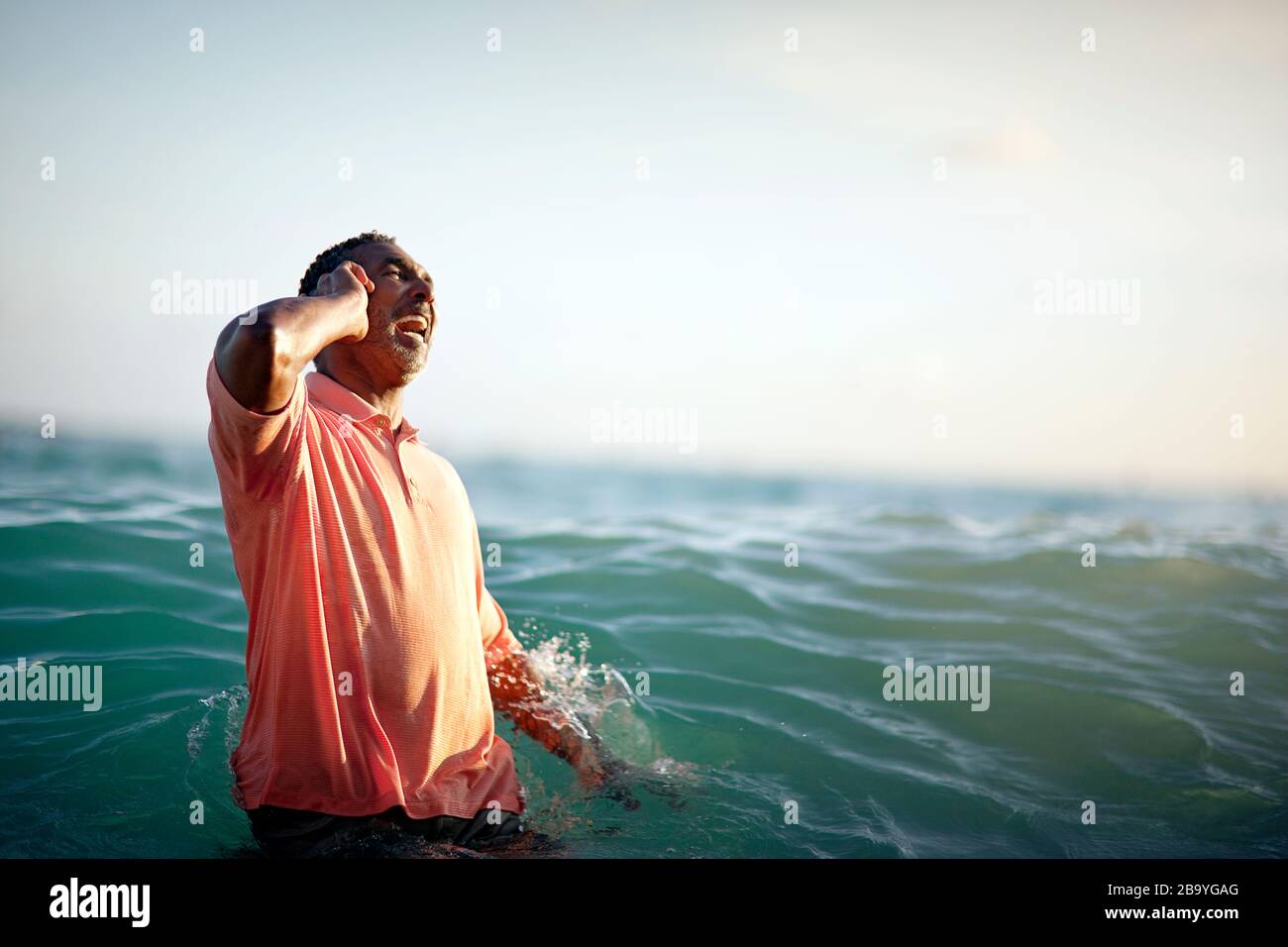 Man standing in ocean waves hi-res stock photography and images - Alamy