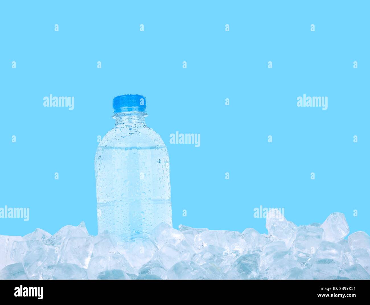 One full PET plastic bottle of cold still drinking water chilling on ...