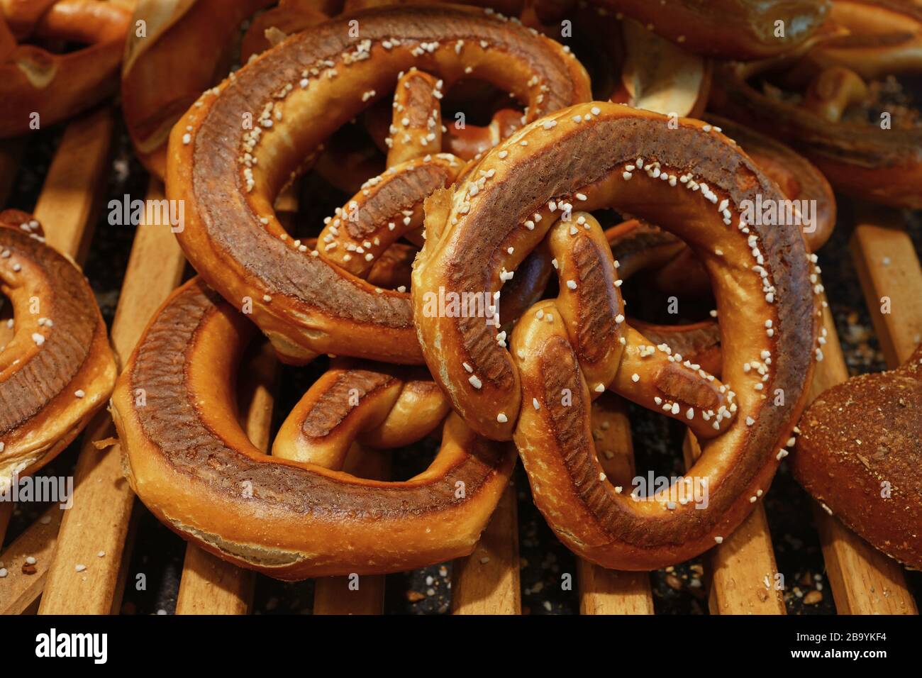 Close up several fresh traditional German pretzel bread knots on retail ...