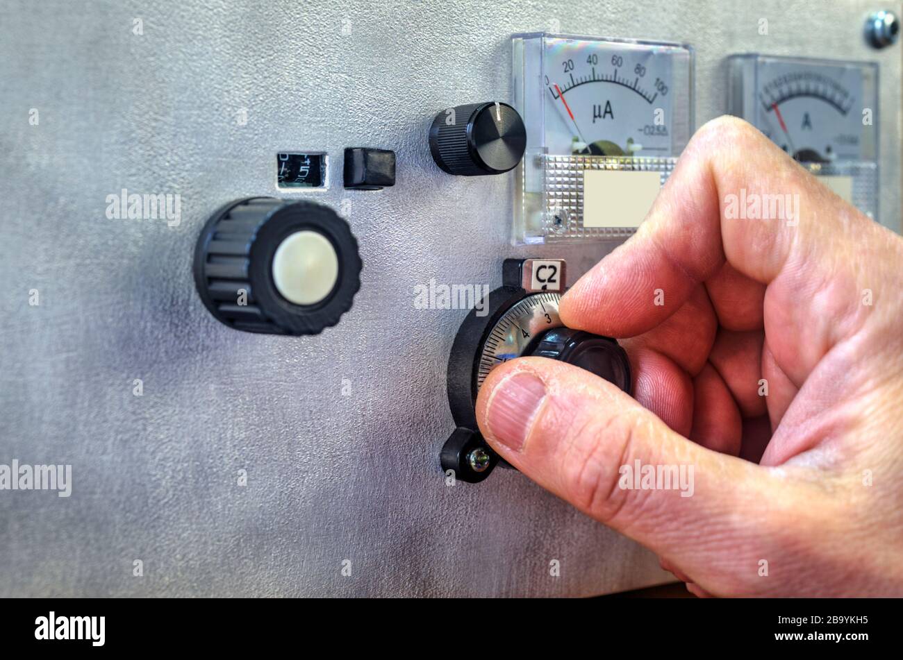 Radio amateur tuning the high frequency power amplifier close up view ...