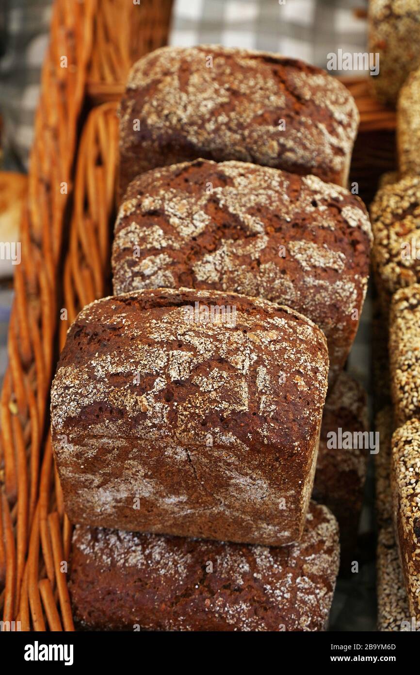 Close up selection of fresh bread loaves on retail display of bakery ...
