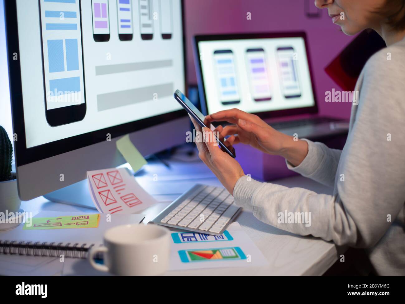 Designers create a user interface for mobile phones Stock Photo - Alamy