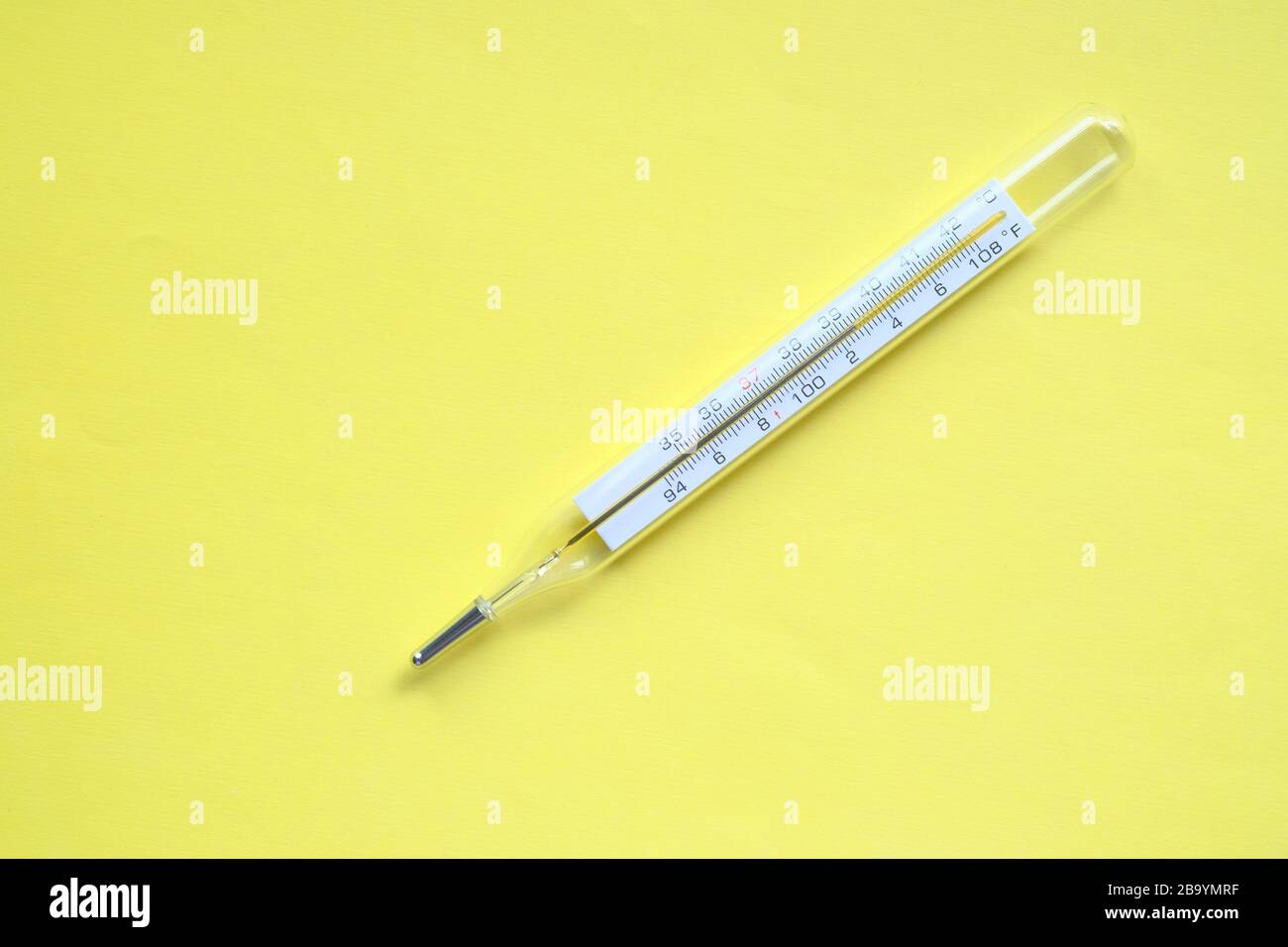 Thermometer on yellow background hi-res stock photography and images ...