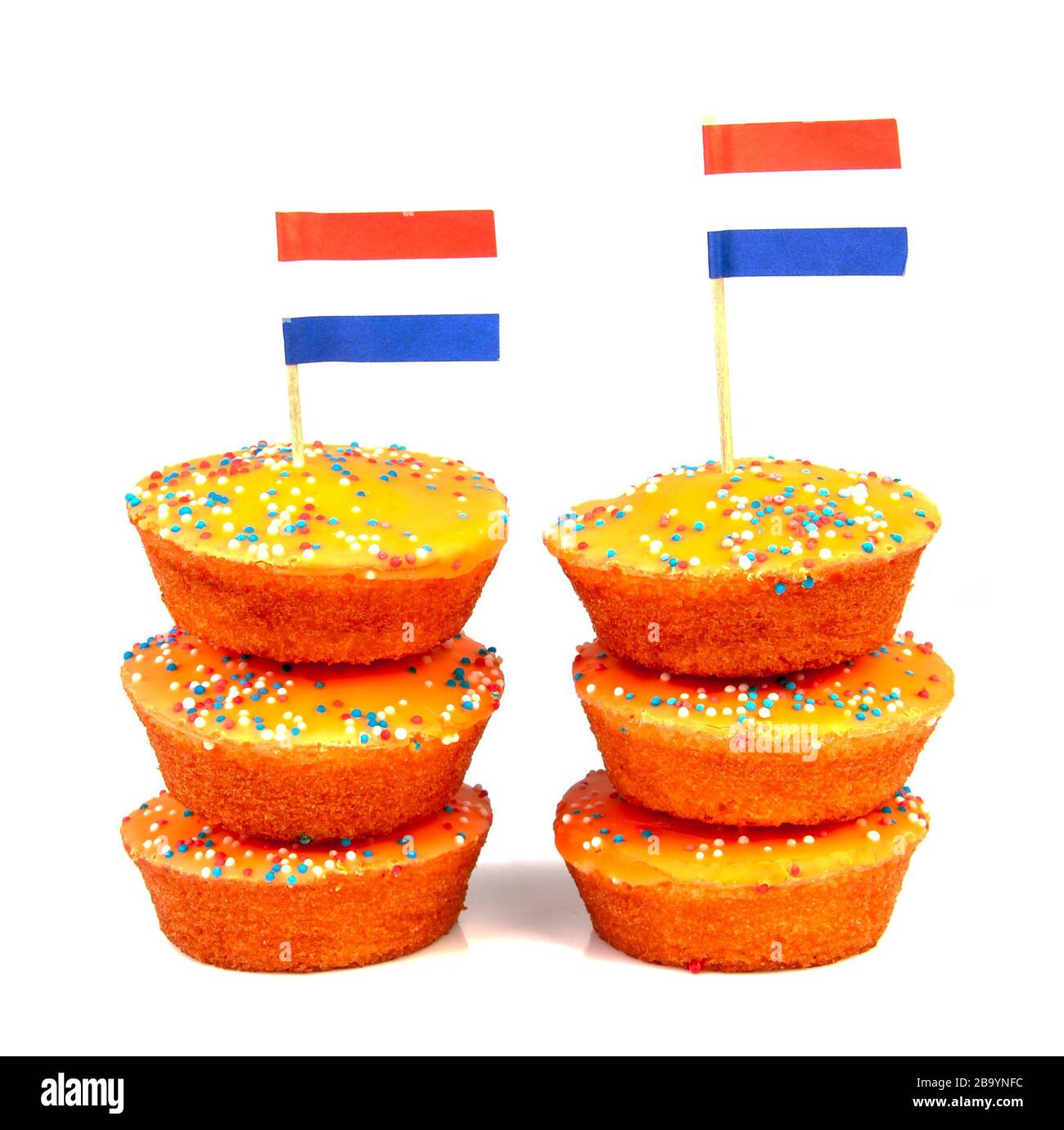 Stacked typical Dutch orange coockies with flags over white background ...