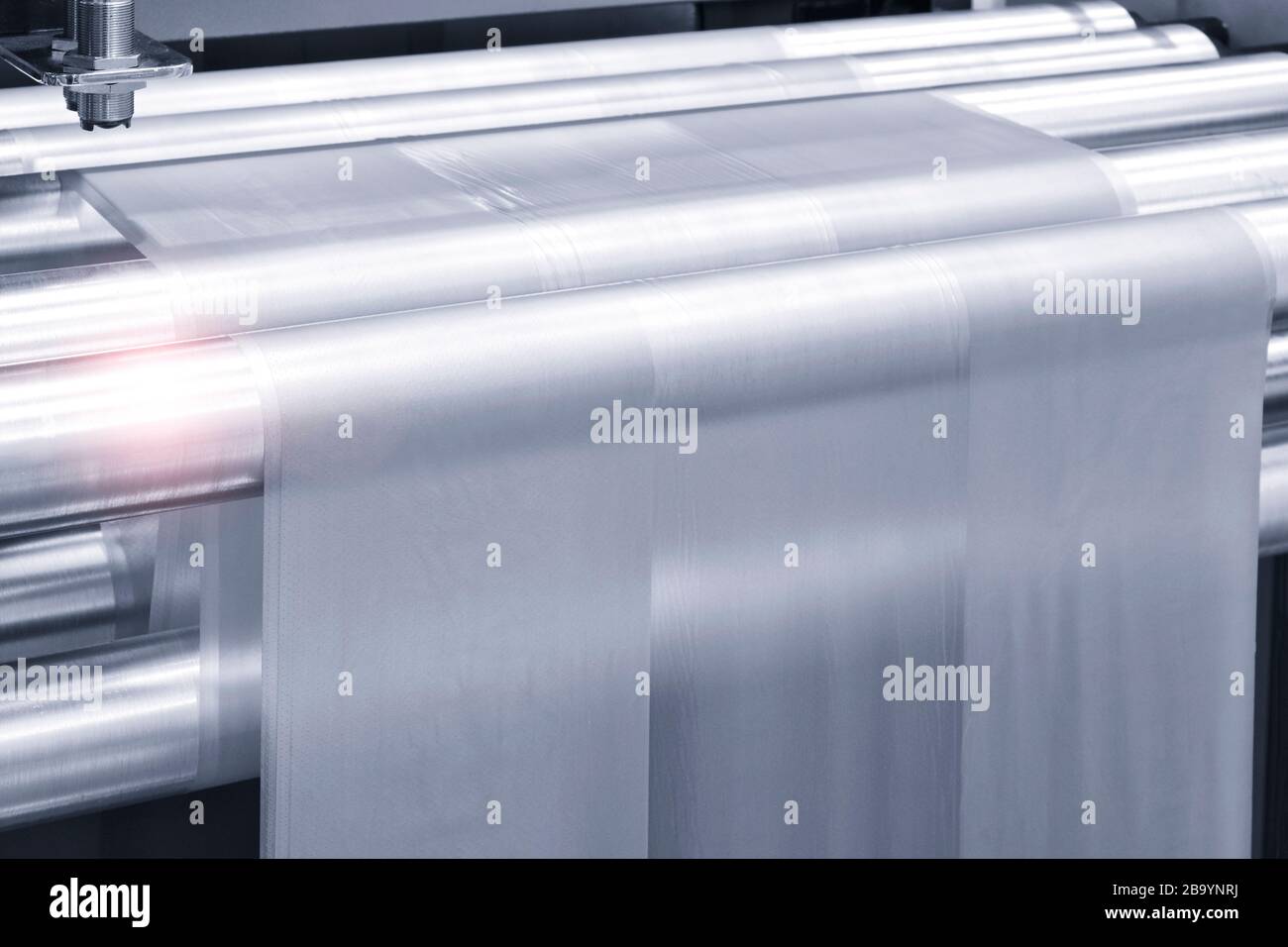 The operation of automatic plastic bag production machine. Close-up of ...