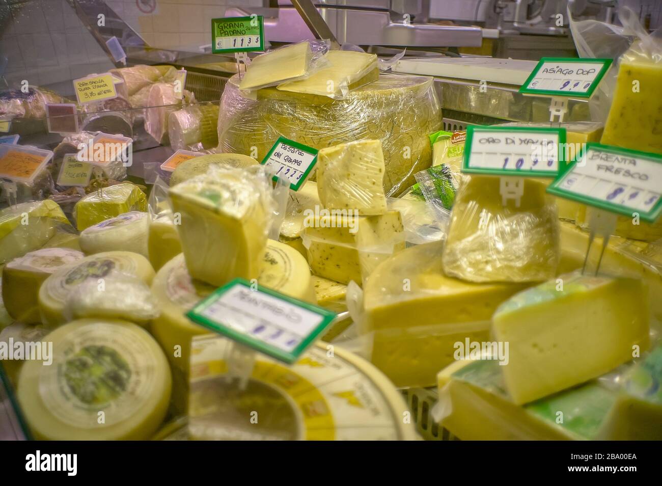 Cheeses on sale on the counter of the grocery store Stock Photo - Alamy