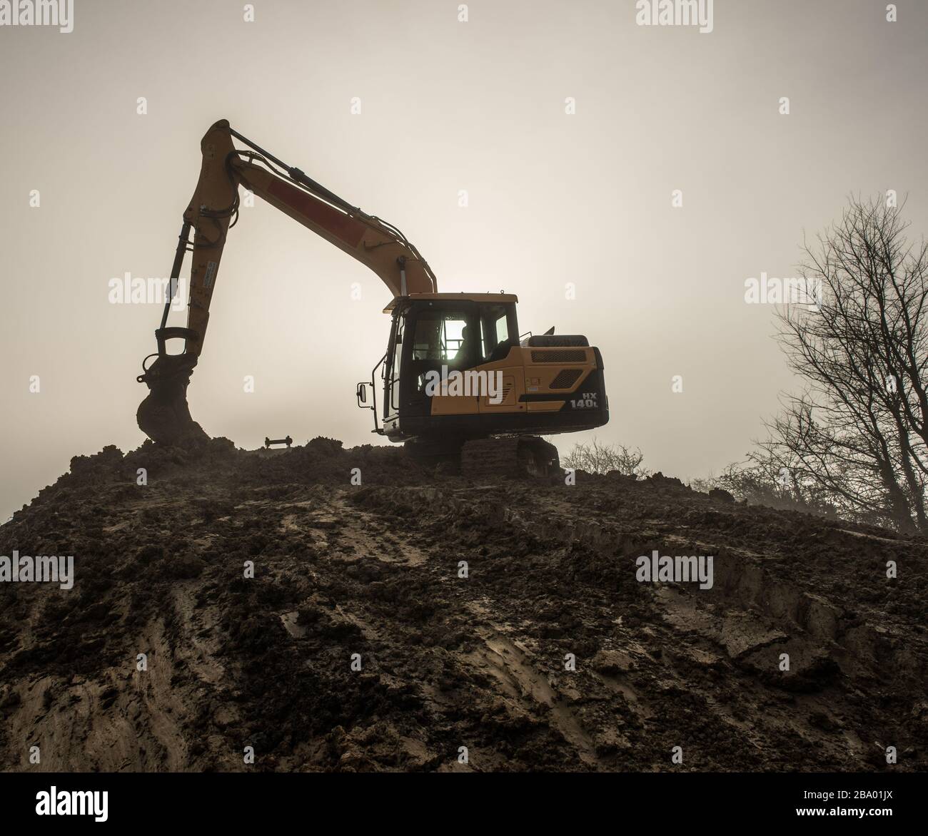 Digger on mound of soil Stock Photo - Alamy