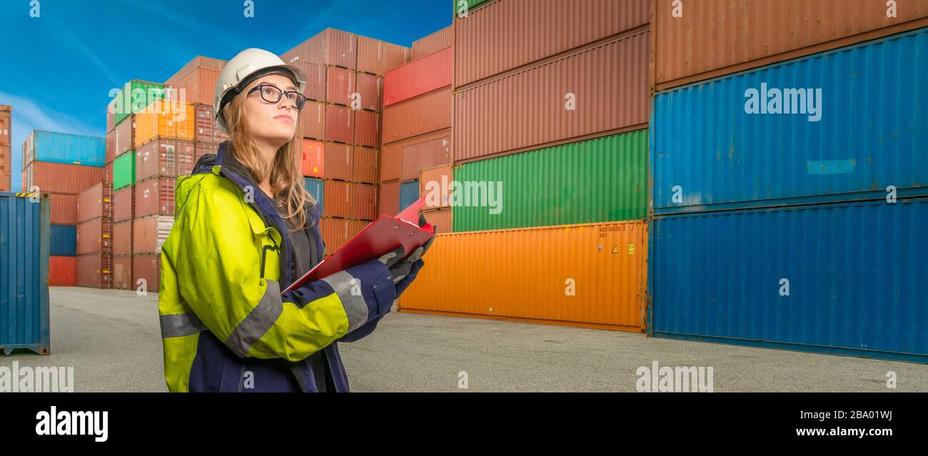 A port employee checks containers in the container terminal Stock Photo ...