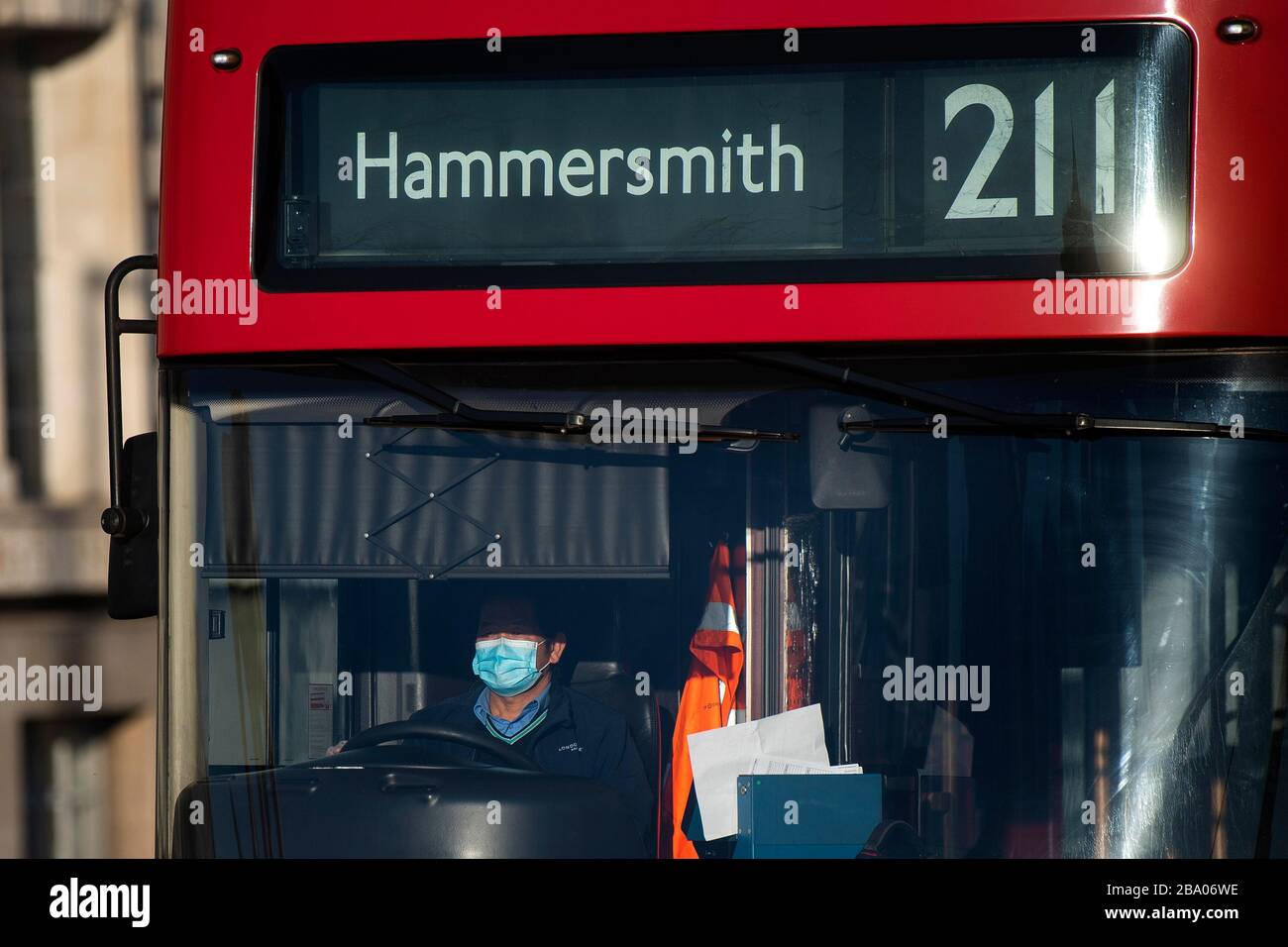 A London bus driver wearing a protective face mask on Westminster ...