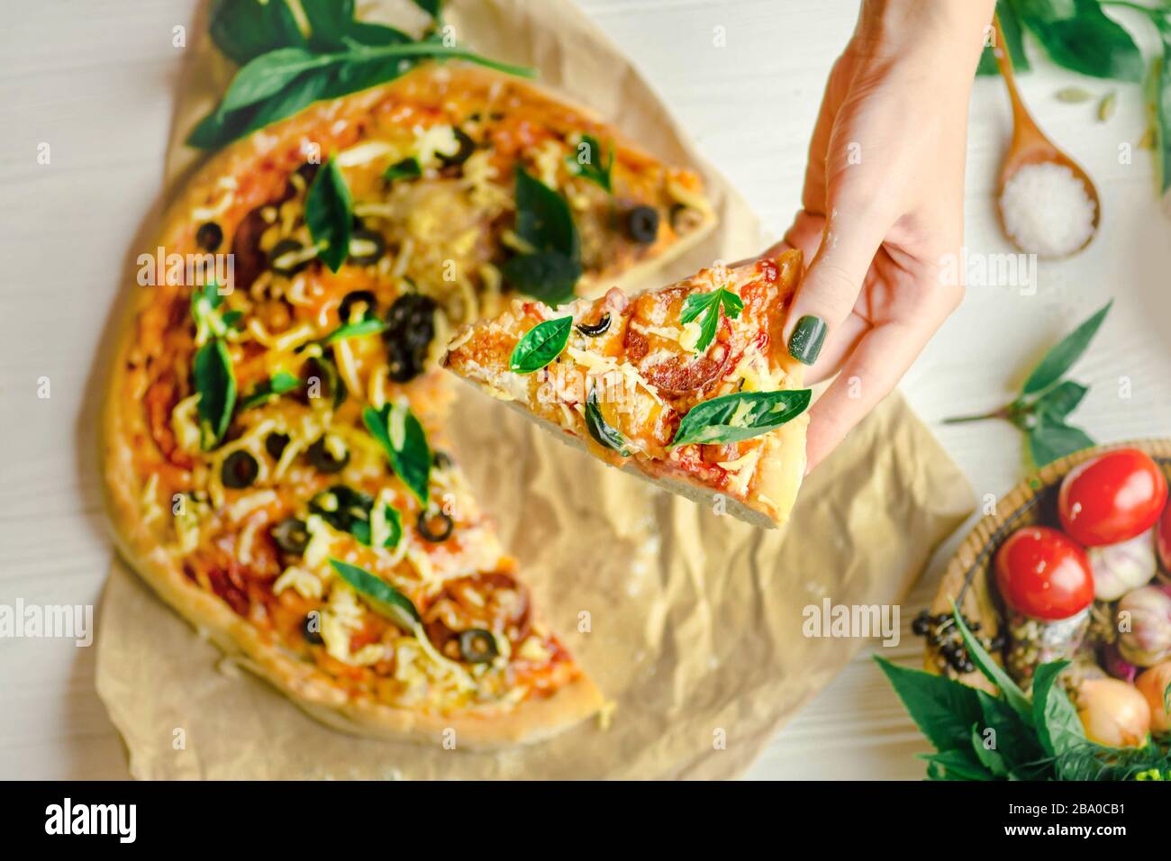 Hand taking pizza slices from white wooden background. Pizza and hand ...