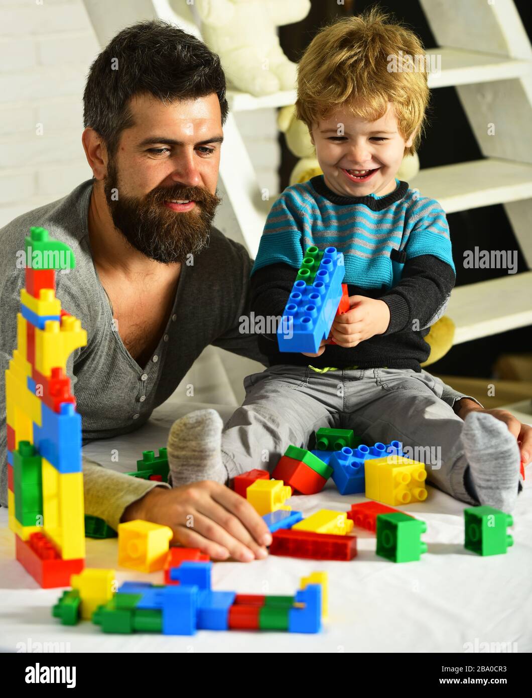 Family and childhood concept. Dad and kid with ladder on background ...