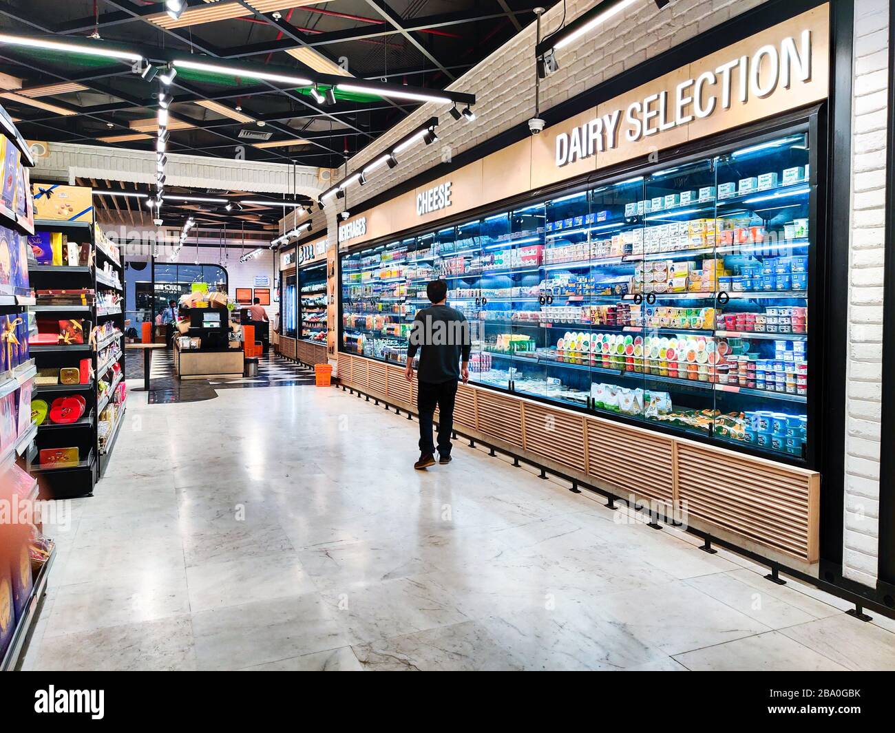 Young indian man looking through the food and drink section of a modern ...