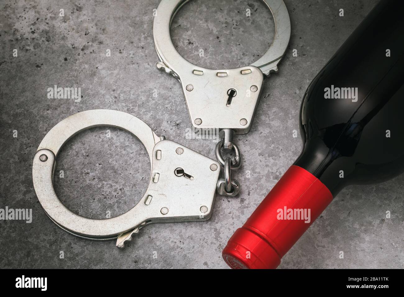 Handcuffs alcohol bottle hi-res stock photography and images - Alamy