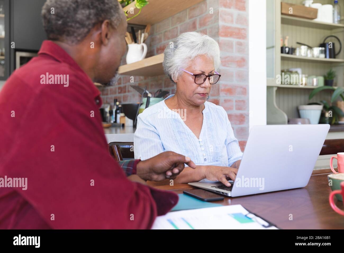 senior African American couple doing their papers using a laptop Stock ...