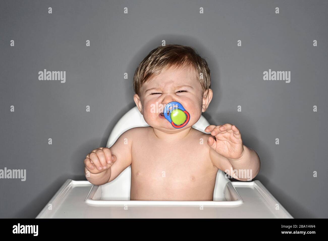 Crying Baby Boy with Pacifier in his Mouth Stock Photo - Alamy
