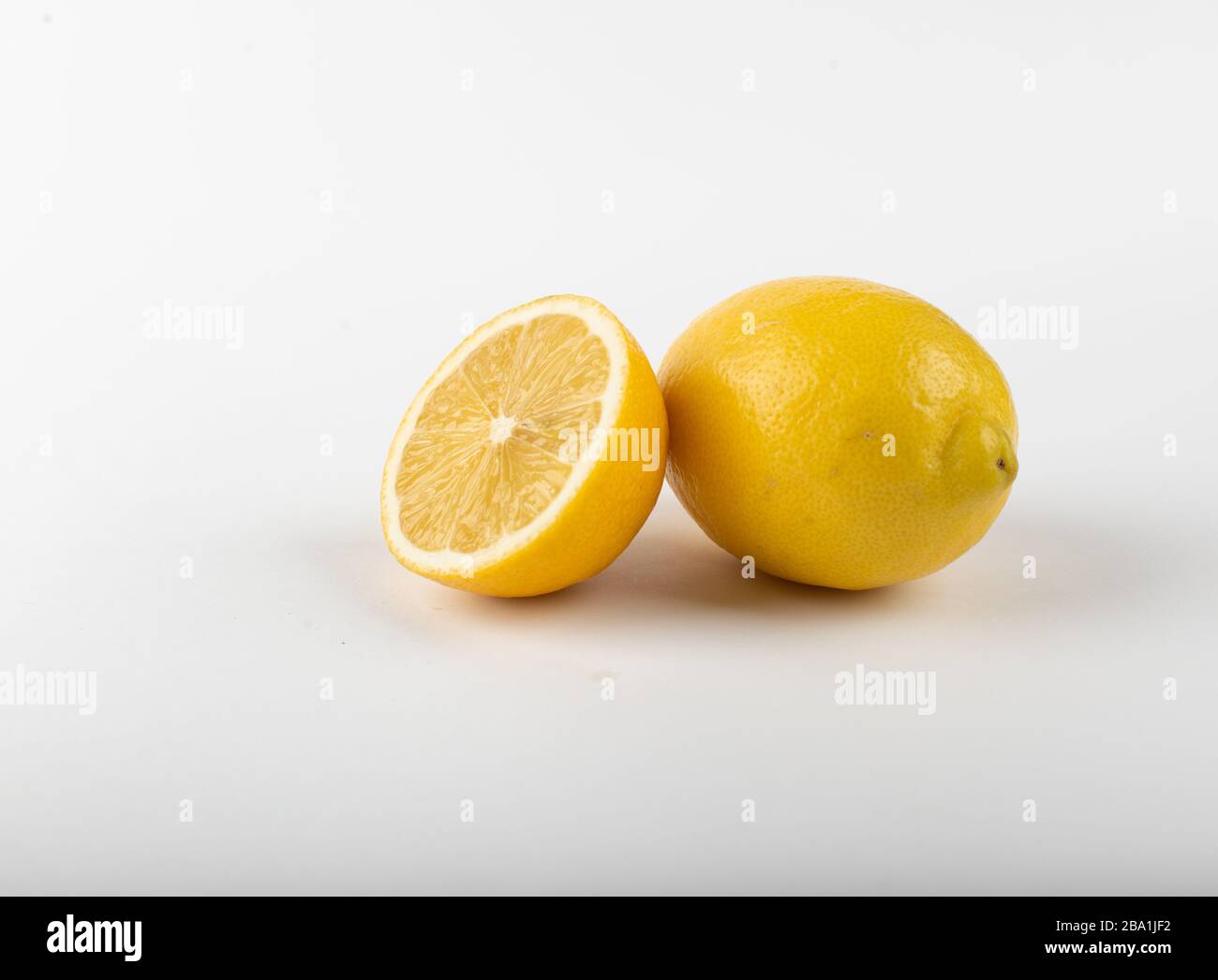Whole and half lemon isolated on white Stock Photo - Alamy