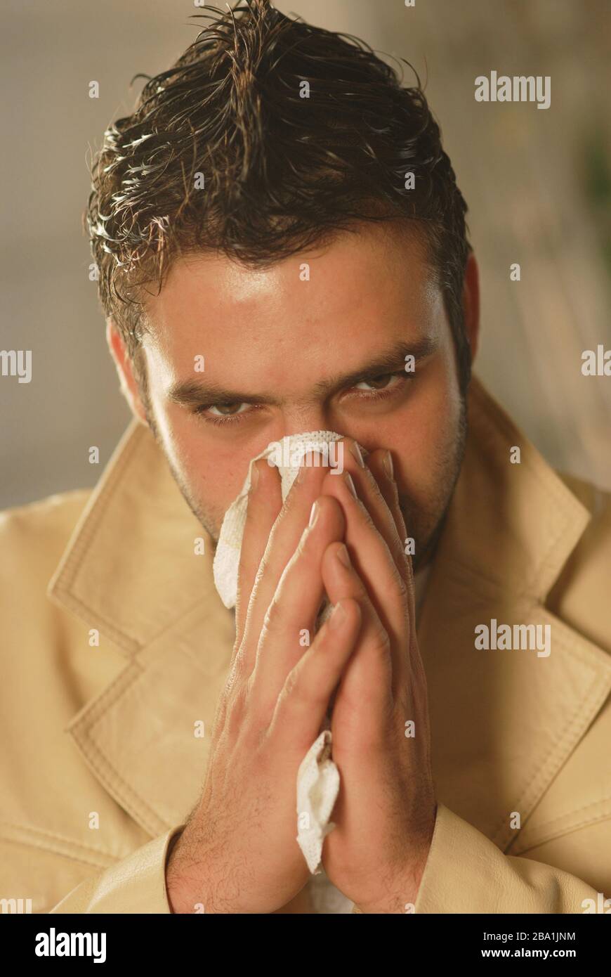 An ill man with a handkerchief Stock Photo - Alamy