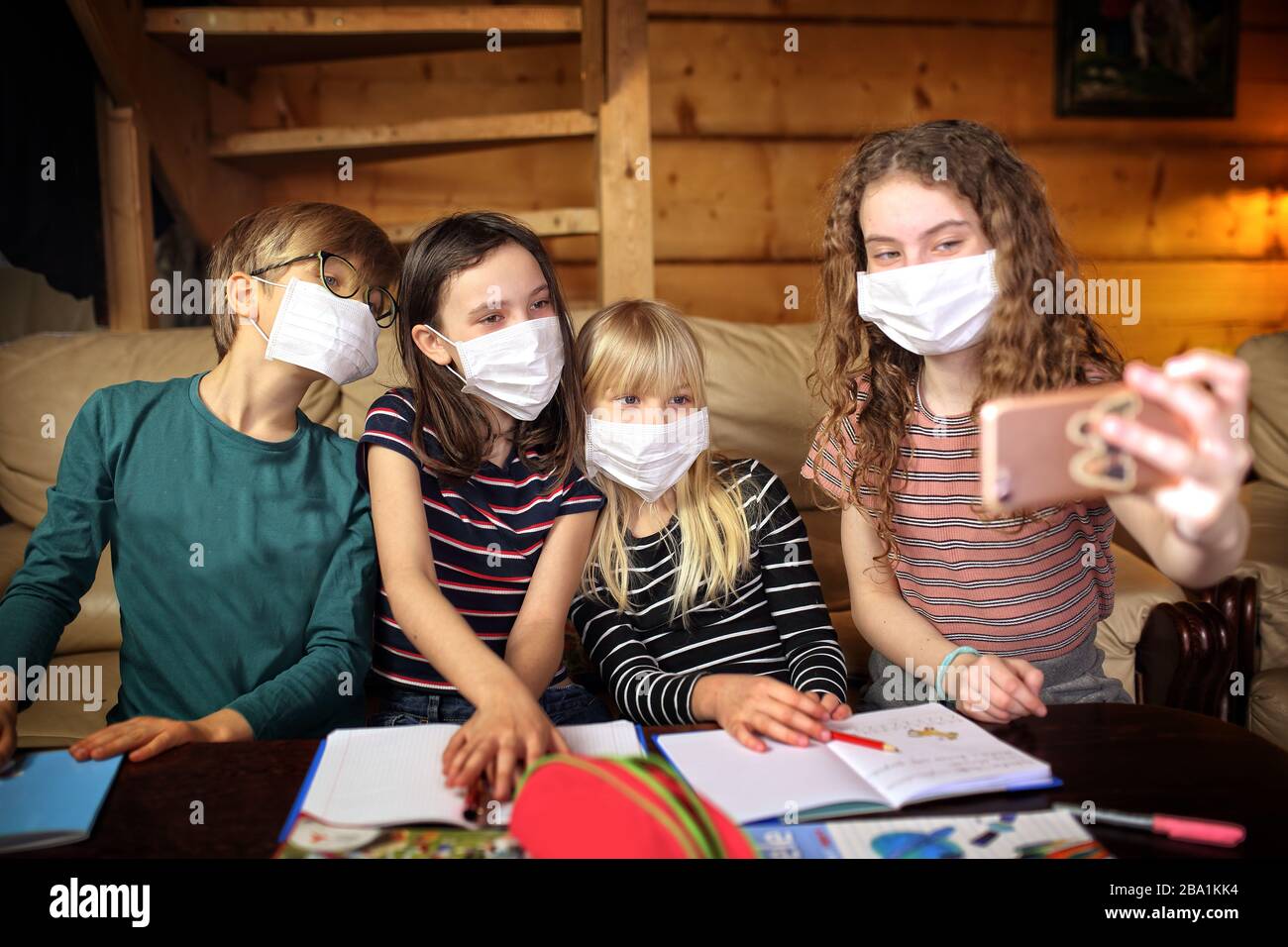 children take pictures wearing masks locked in their homes by a ...