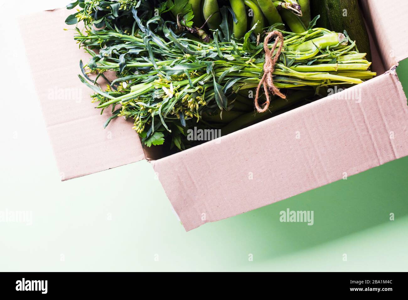Green produce in cardboard box Stock Photo - Alamy