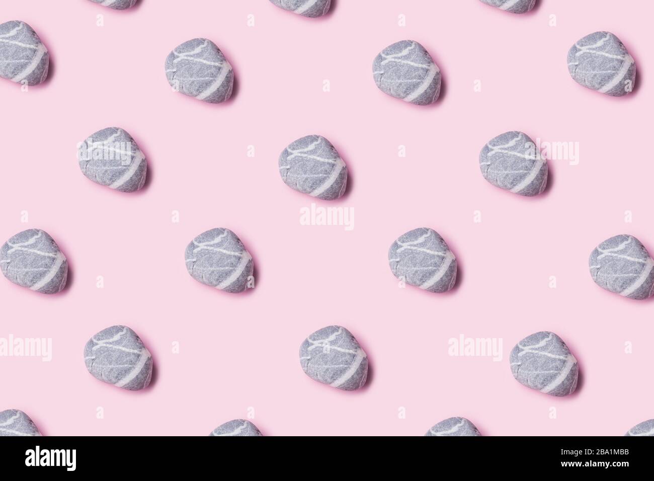 Sea pebble pattern on pastel pink background Stock Photo - Alamy