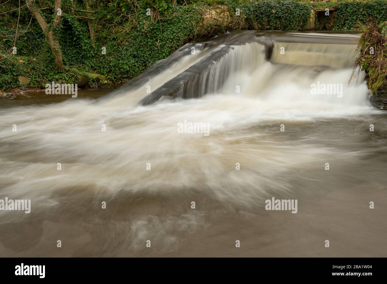 Long exposure of a waterfall on the river Avill in Dunster in Somerset ...