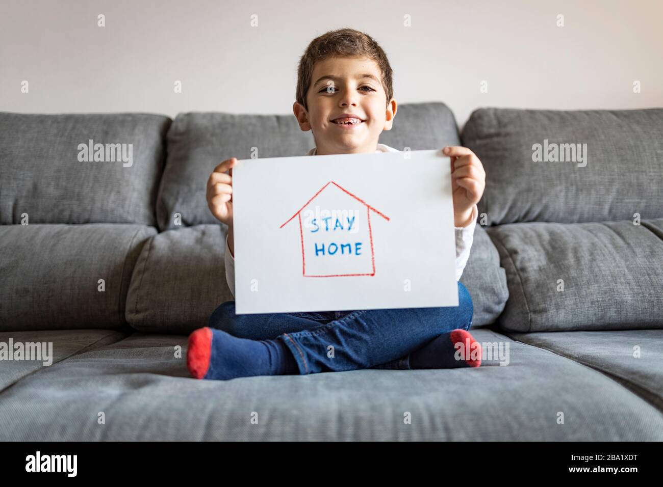 Little kid with a say home drawing Stock Photo - Alamy