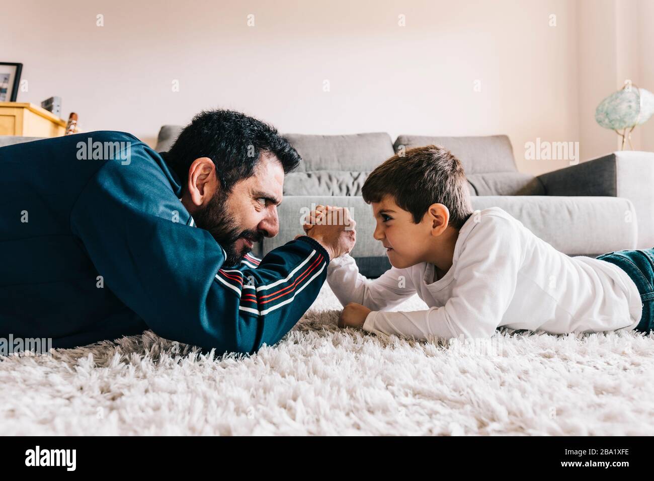 Father son arm wrestling home hi-res stock photography and images - Alamy