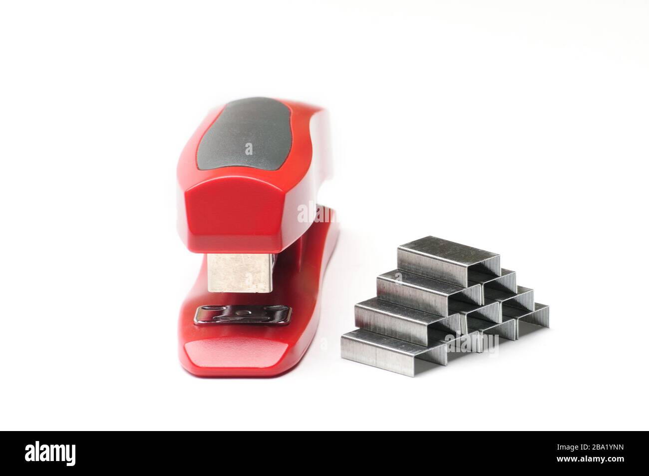 Red office stapler on an isolated white background Stock Photo - Alamy