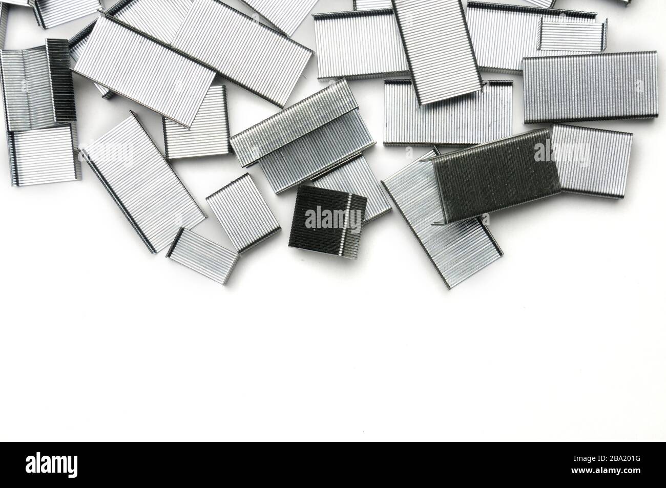 Paper clips from a stapler on an isolated white background Stock Photo ...