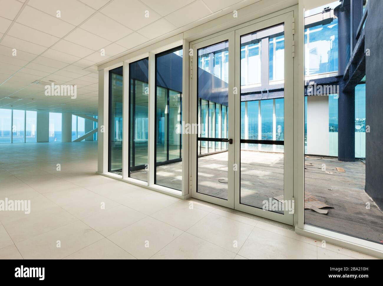Interior, wide open space, skyscraper, windows overlooking the sea ...