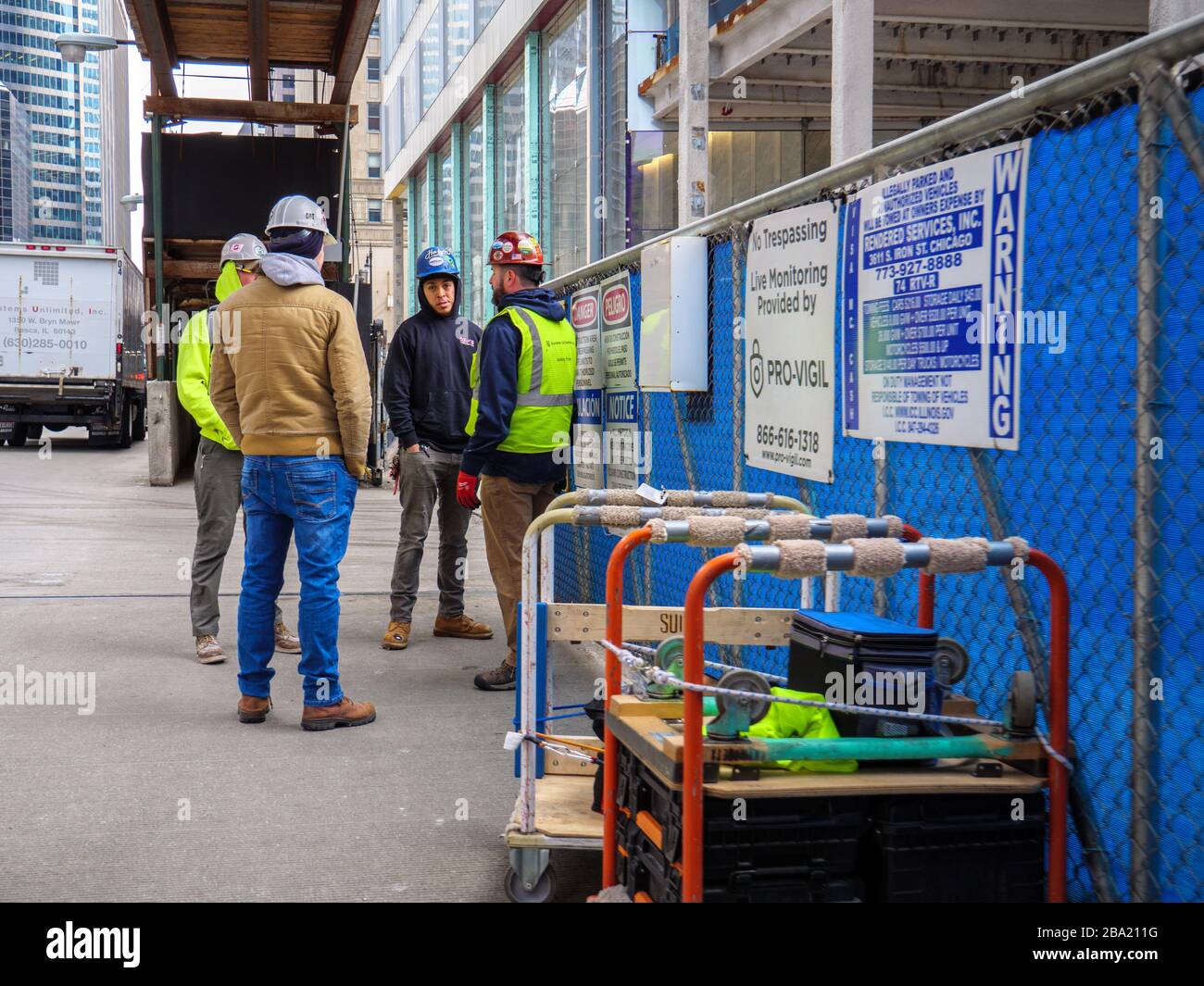 Chicago, Illinois, USA. 24th March 2020. Construction workers take a ...