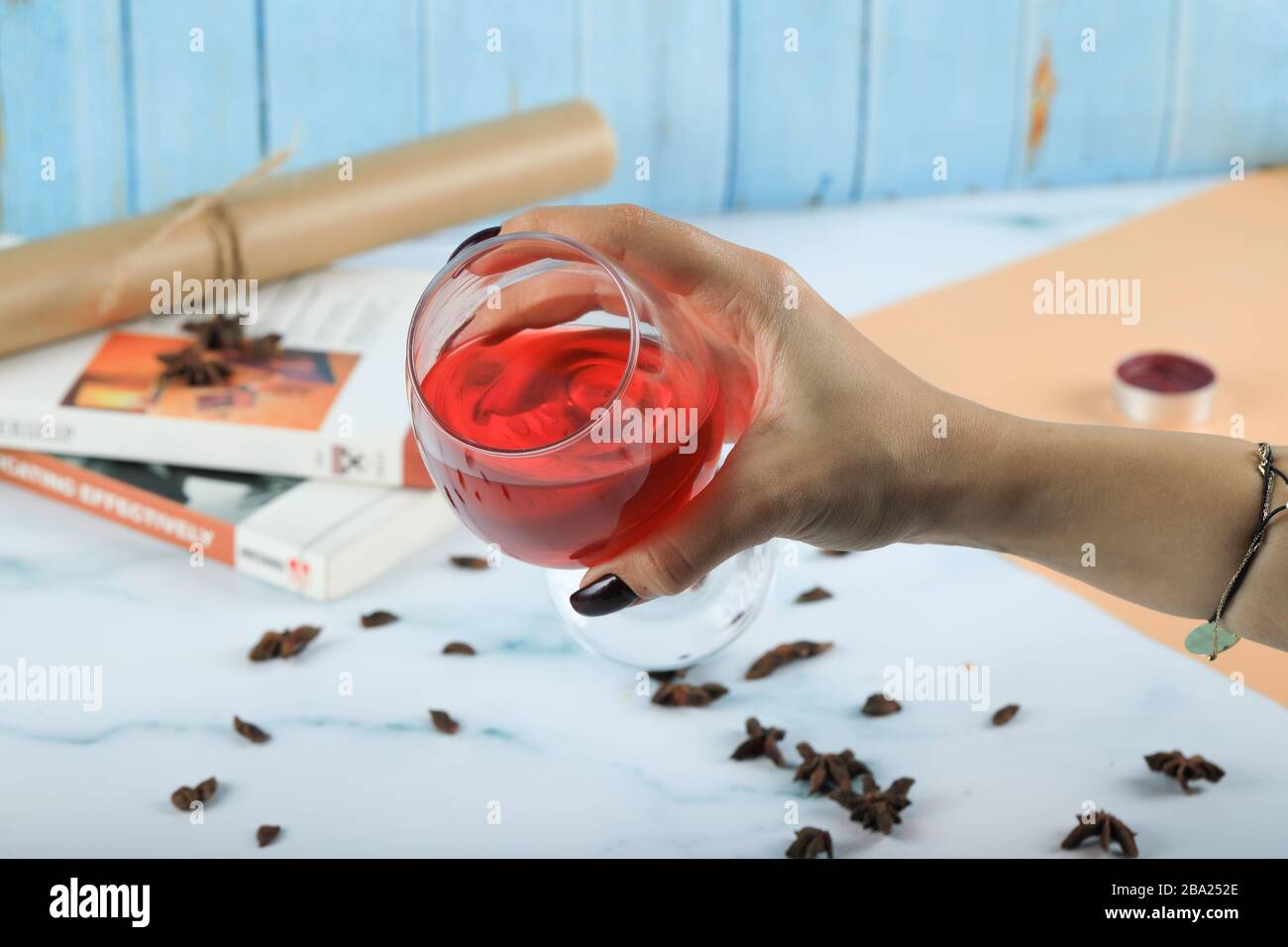 Shaking the glass of red rose wine in the hand, top view Stock Photo ...