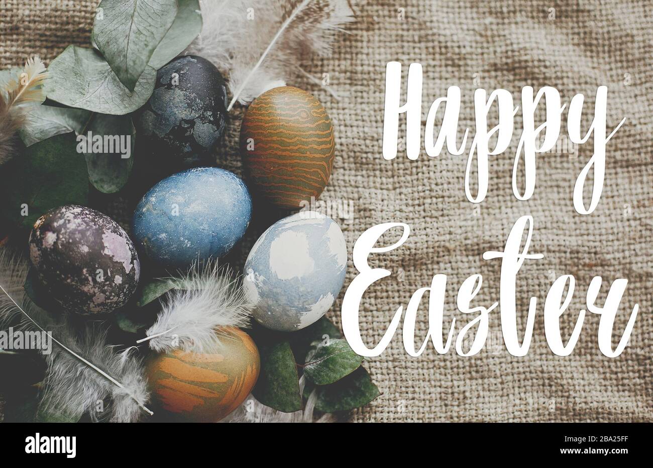 Happy Easter text. Easter greetings card. Stylish easter eggs in rustic ...