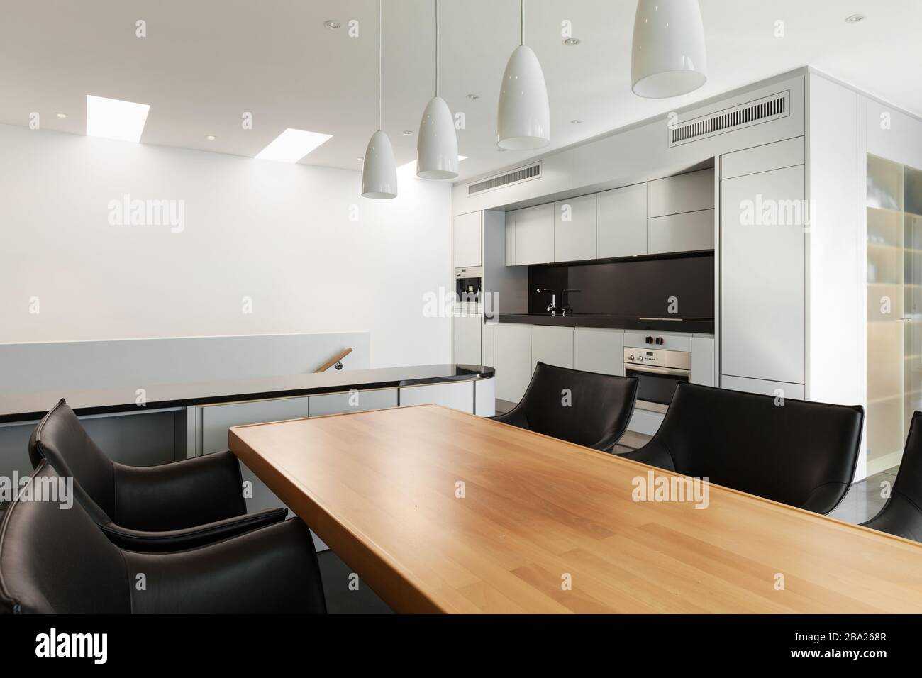 modern house, white kitchen, view from dining table Stock Photo - Alamy