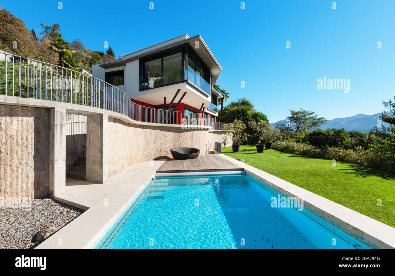 Modern villa with pool, view from the garden Stock Photo - Alamy