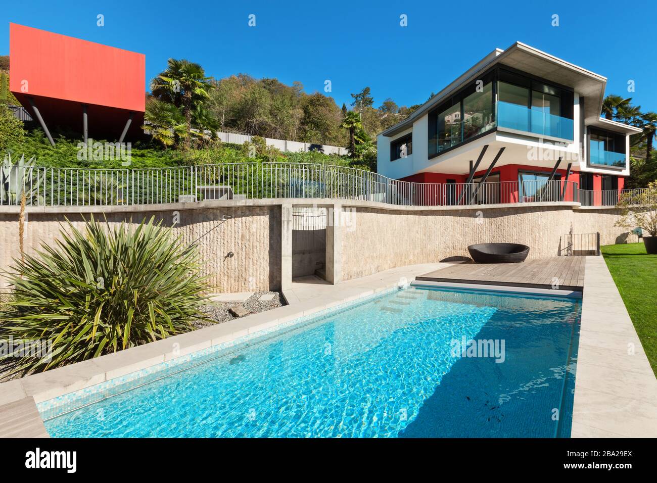 Modern villa with pool, view from the garden Stock Photo - Alamy
