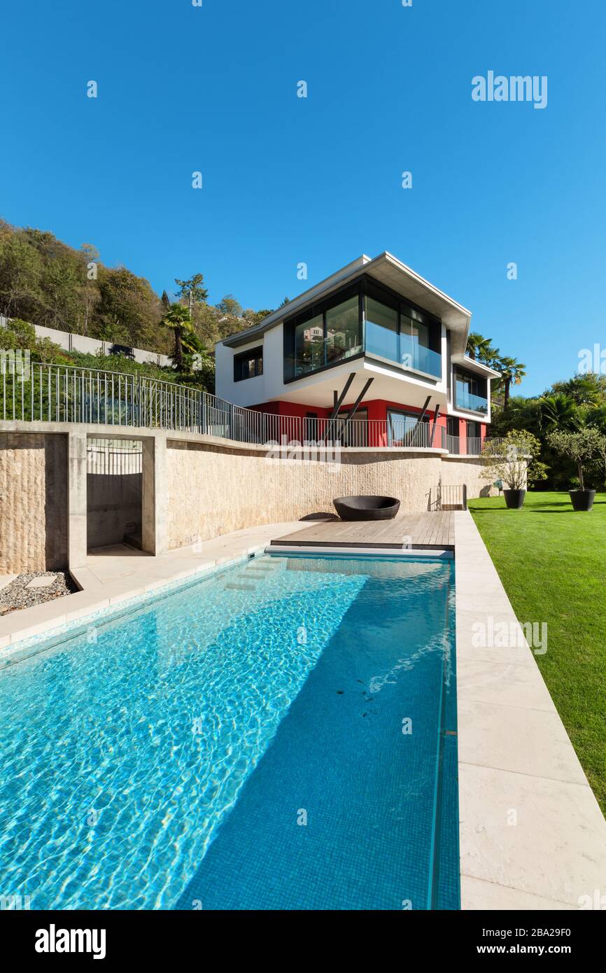 Modern villa with pool, view from the garden Stock Photo - Alamy