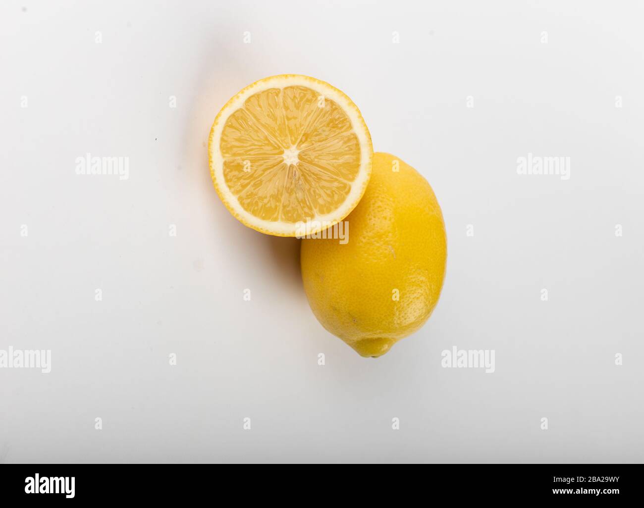Whole and half lemon isolated on white. top view Stock Photo - Alamy