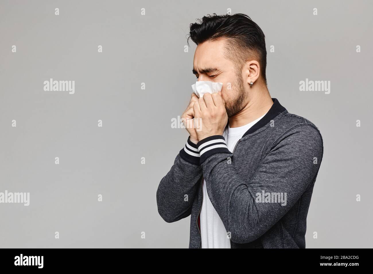 Young sick man having snotty nose, temperature and feeling bad. Sick ...