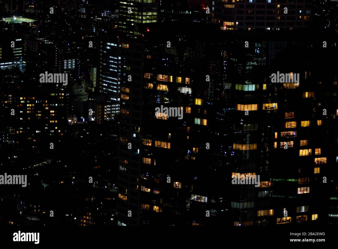 City skyscraper windows with lights at night Stock Photo - Alamy