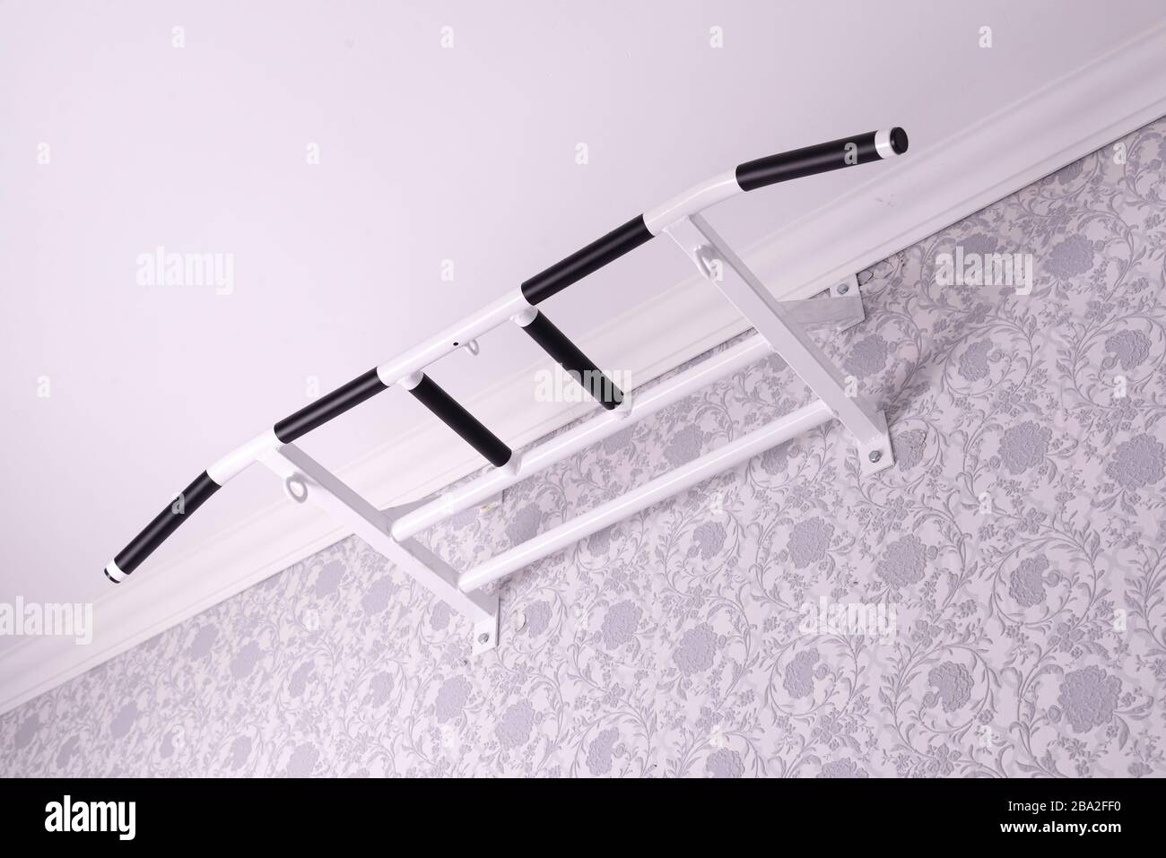 White horizontal bar for pull-ups at home Stock Photo - Alamy