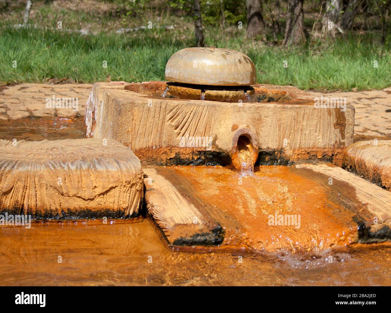 Detail of a stone fountain with running water Stock Photo - Alamy