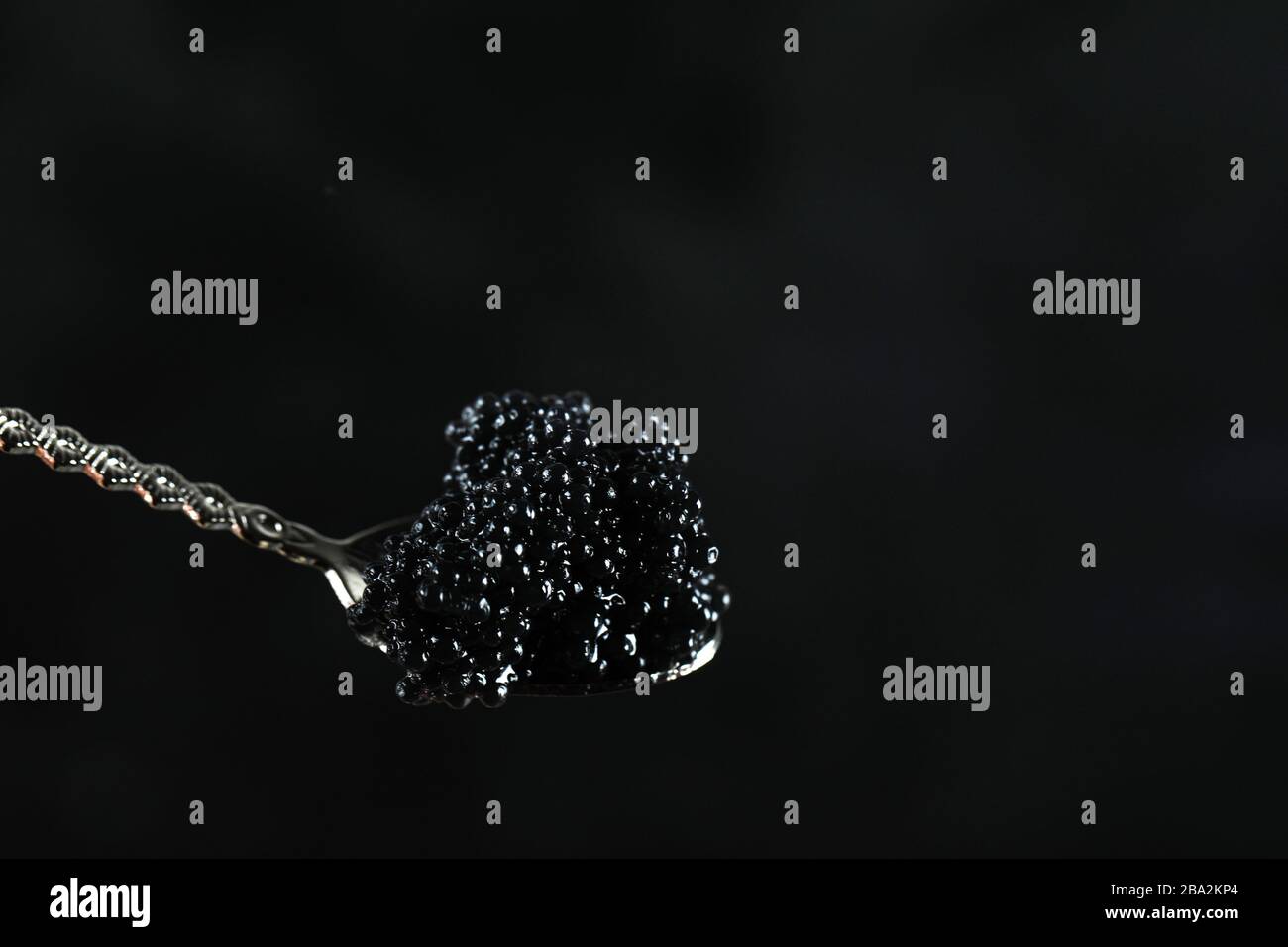 Black caviar in a metallic decorative spoon Stock Photo - Alamy