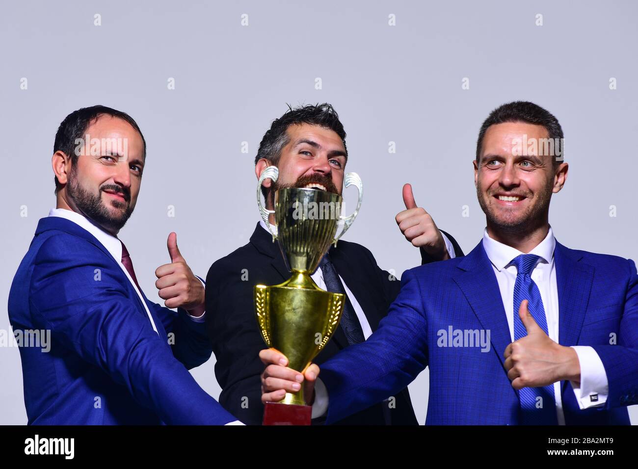 Partners celebrate winning competition. Company leaders hold golden ...